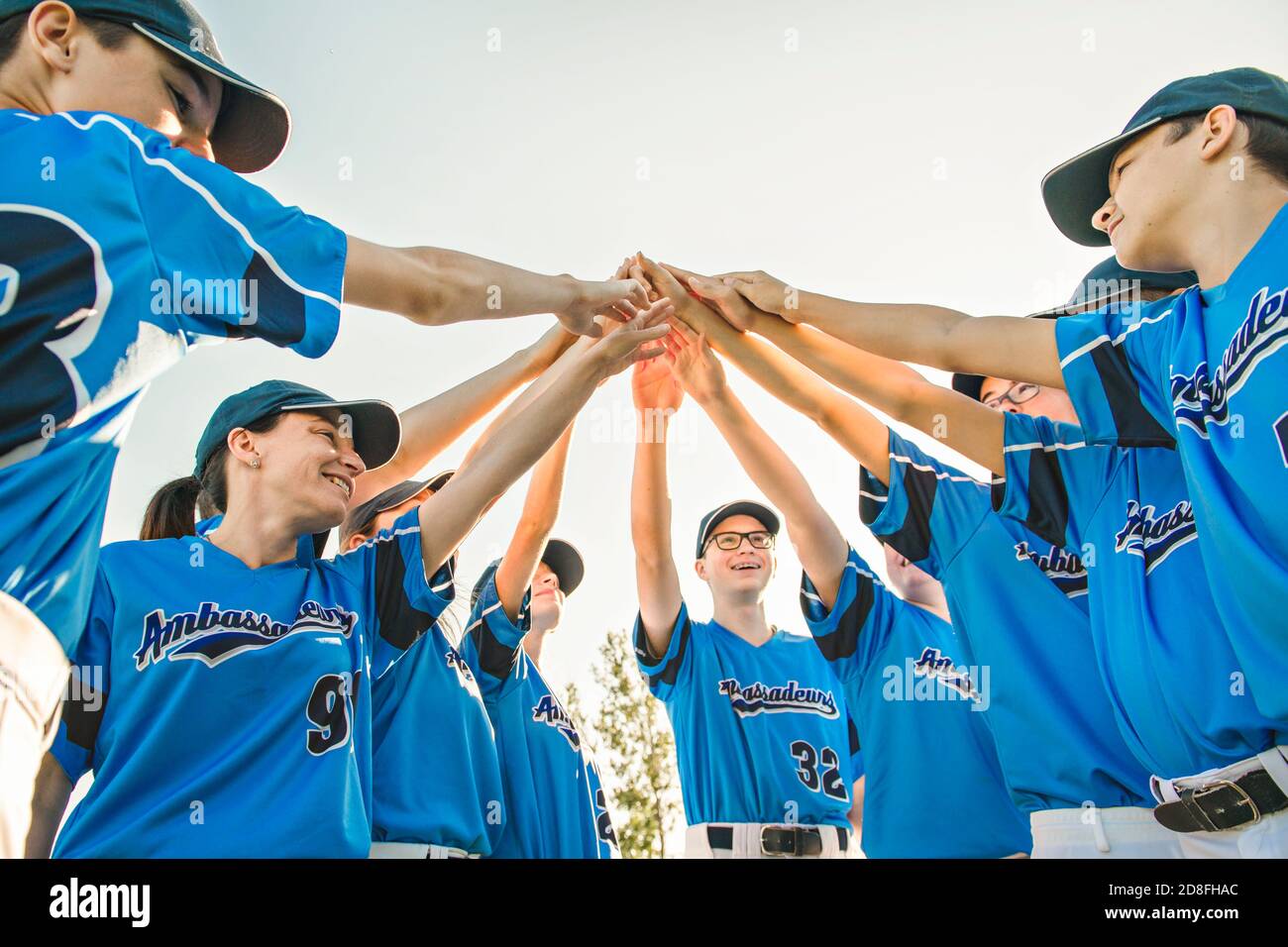 Group of baseball players standing together on the playground with hand ...