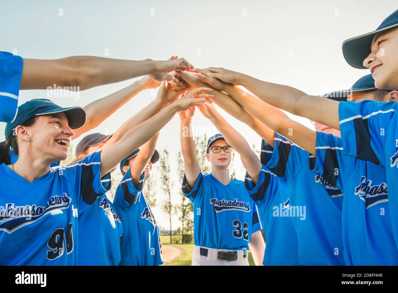 Group of baseball players standing together on the playground with hand ...