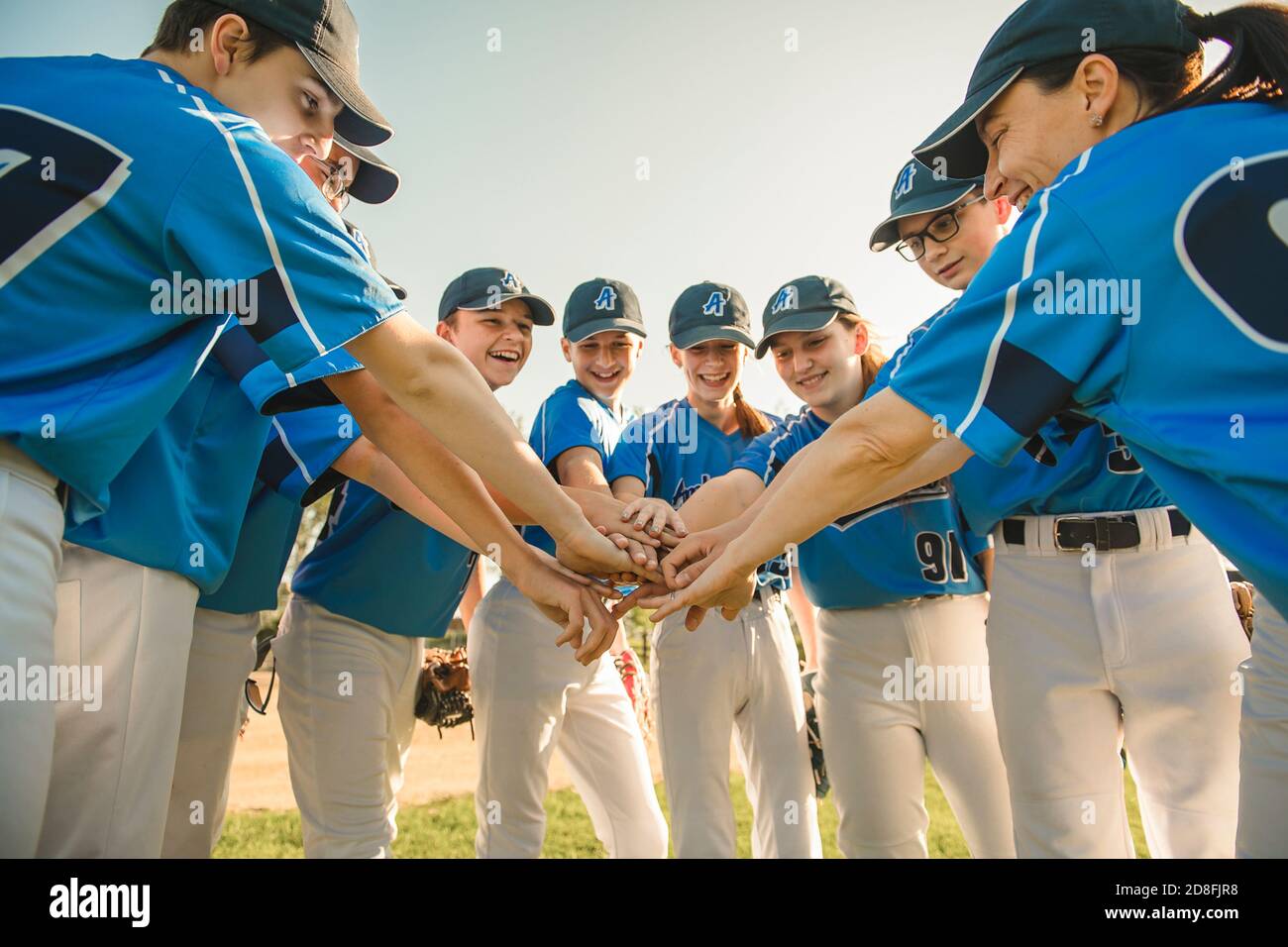 Group of baseball players standing together on the playground with hand ...