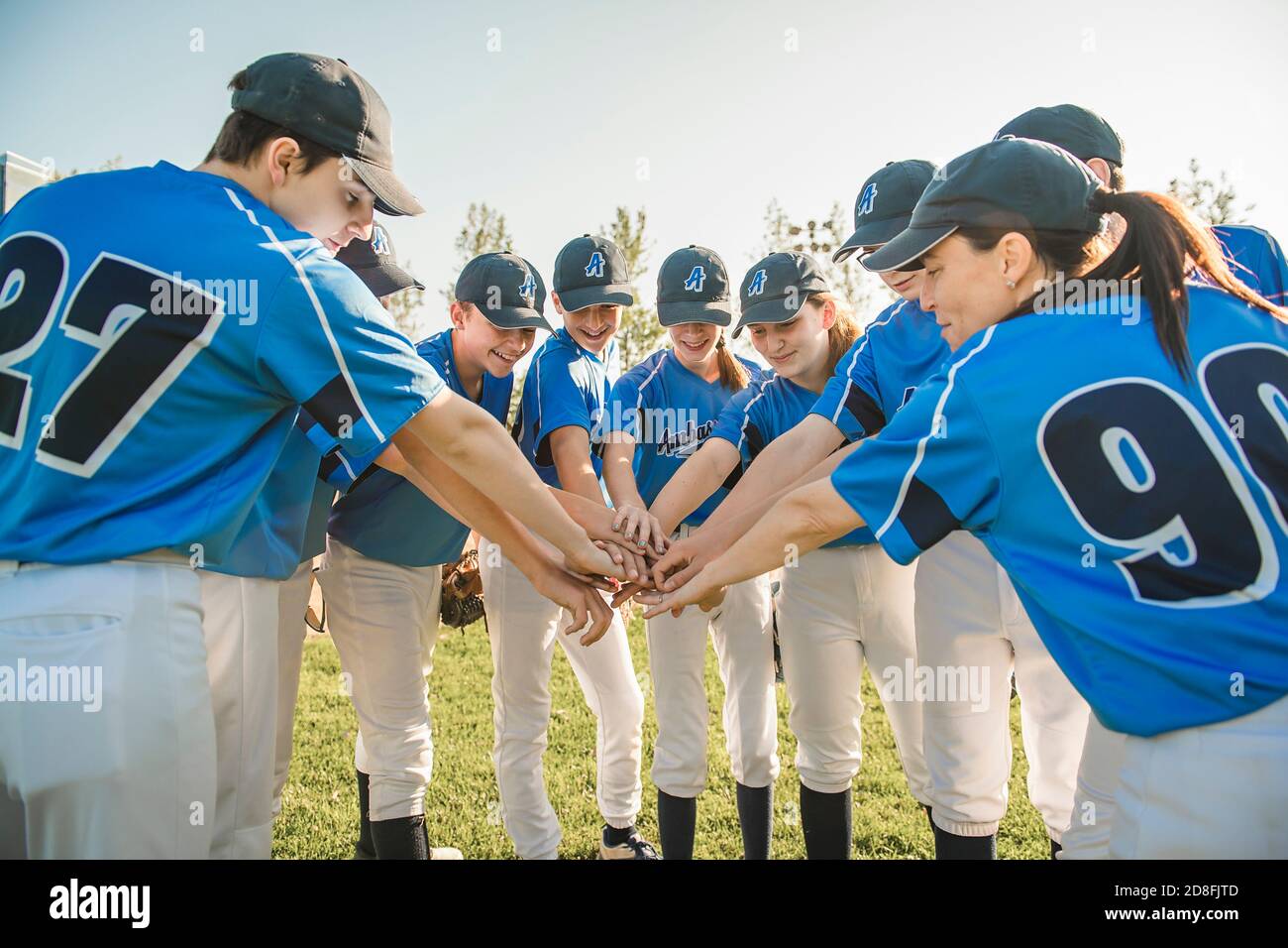 Group of baseball players standing together on the playground with hand ...