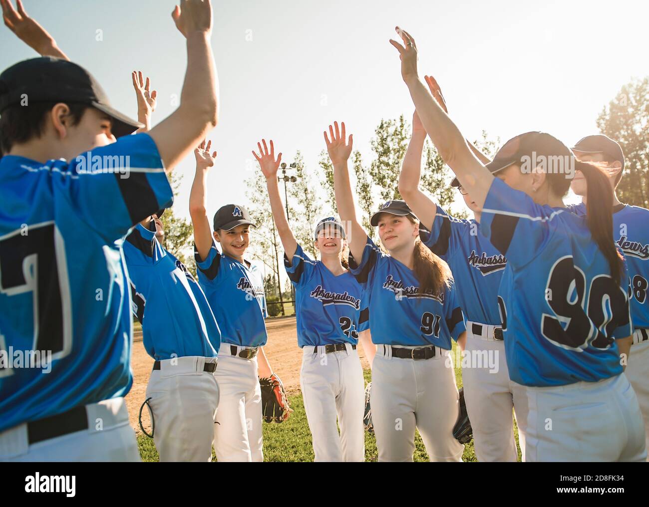 Group of baseball players standing together on the playground with hand ...