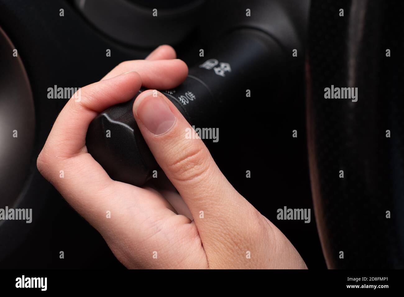 Close-up Female hand switches the turn signal lever, turns on lighting ...
