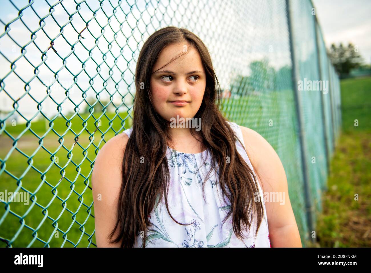 A Portrait of trisomie 21 adult girl outside at sunset Stock Photo - Alamy