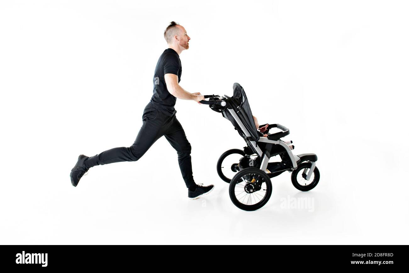 A father jogging with a baby stroller Stock Photo - Alamy