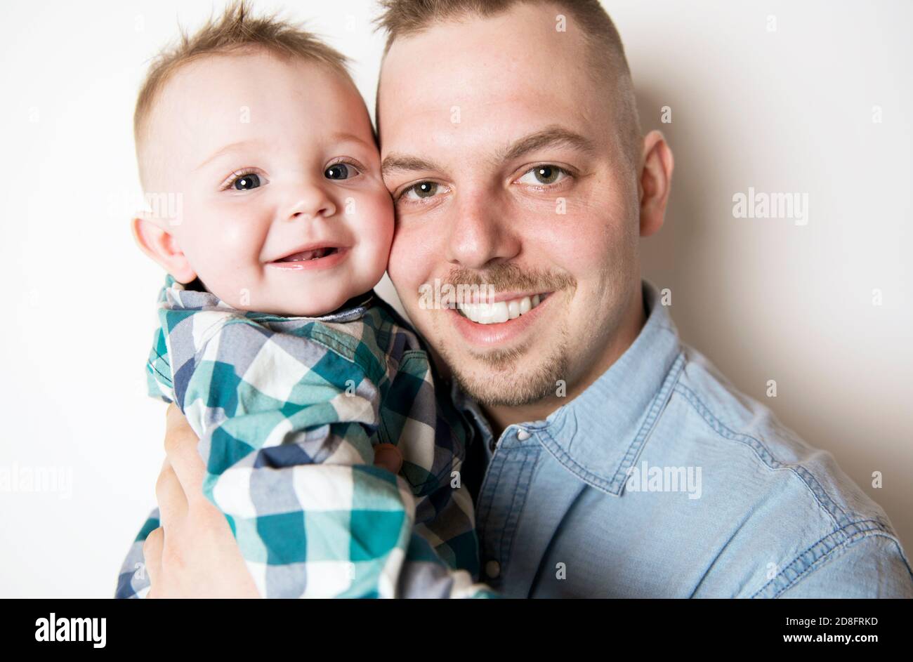 A father with the baby boy on studio white background Stock Photo - Alamy