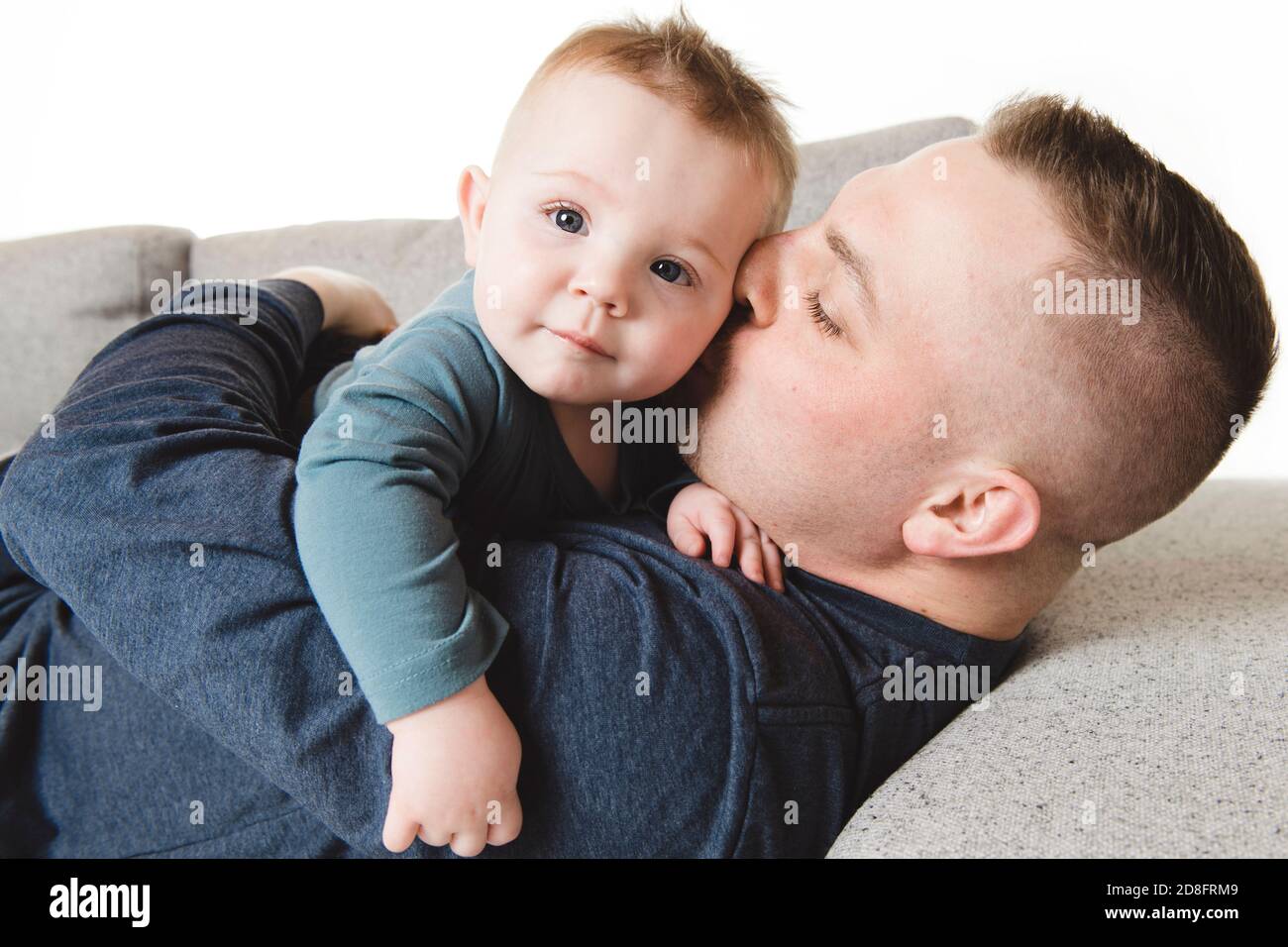A father and baby boy playing on sofa Stock Photo - Alamy