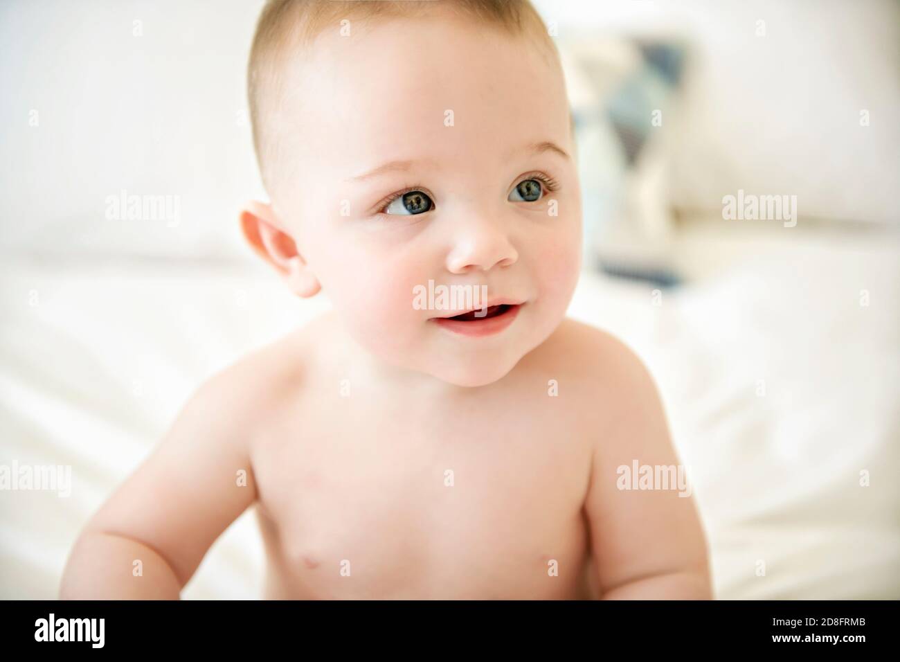 cute baby boy lying on a white bed Stock Photo - Alamy