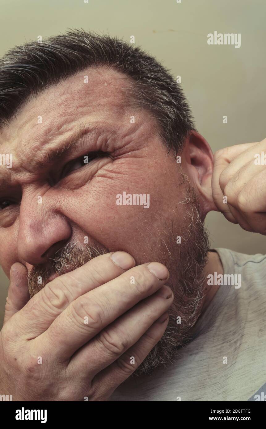 An unusual portrait of a man who is being pulled by the ear. A grown ...