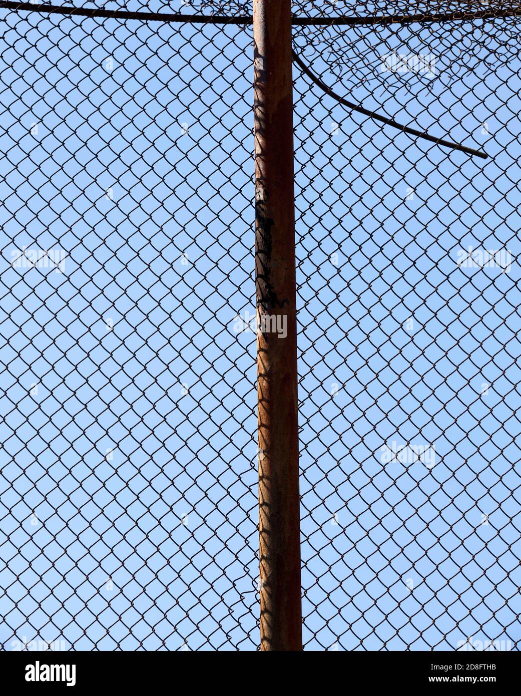 old wire fence made of thin wire against the blue sky Stock Photo - Alamy