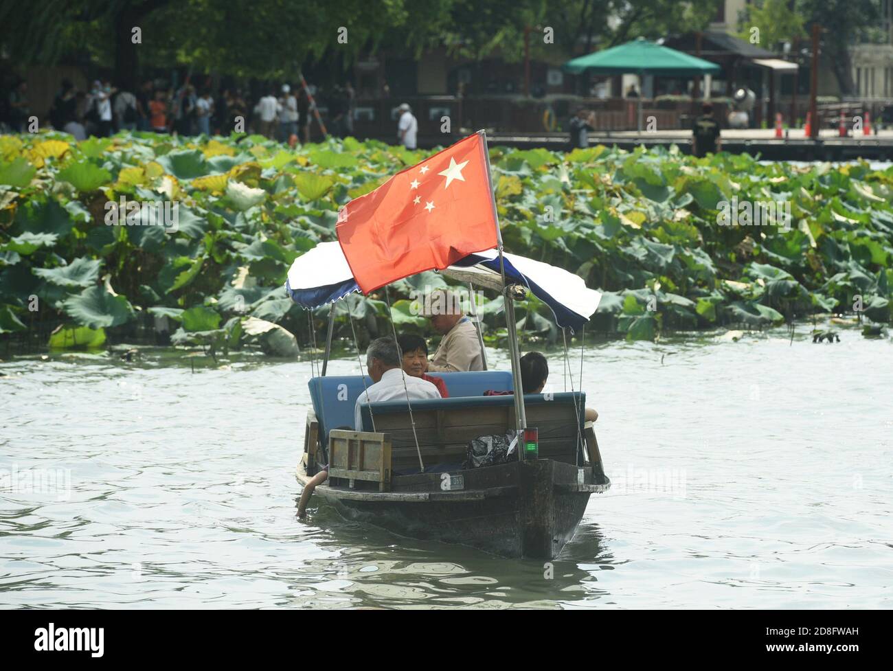 National flags of China fly on the boat in the West Lake, welcoming the ...