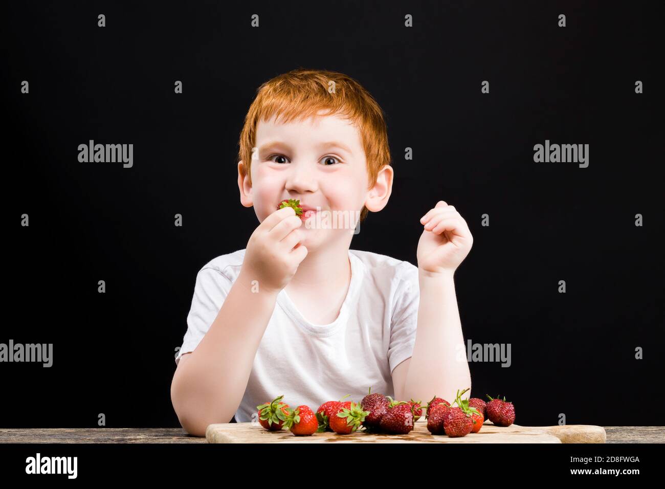 Boy eats strawberries hi-res stock photography and images - Alamy