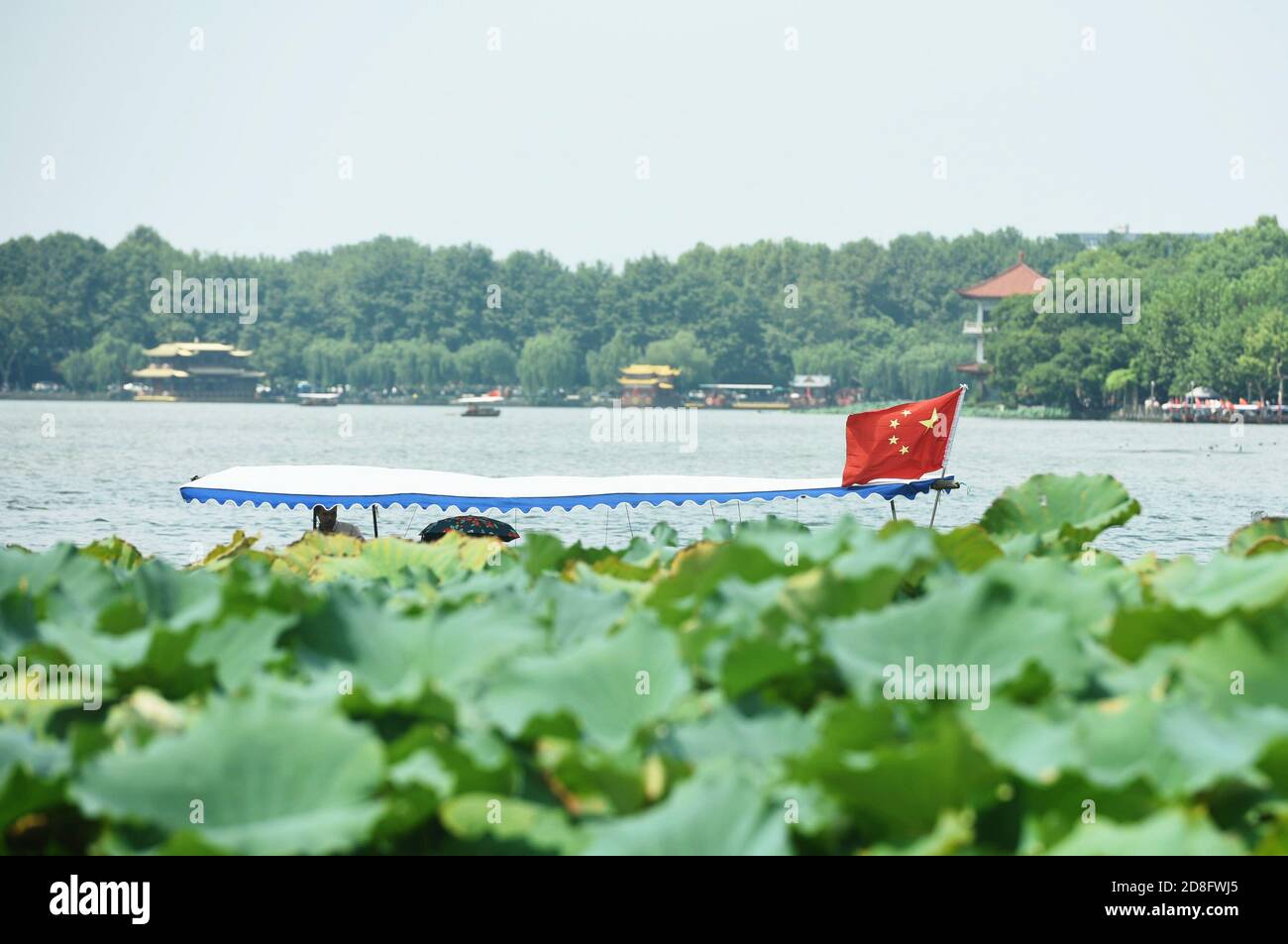 National flags of China fly on the boat in the West Lake, welcoming the ...