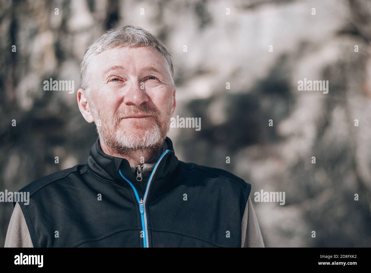 Portrait of an unshaven attractive and happy middle aged man outdoors ...