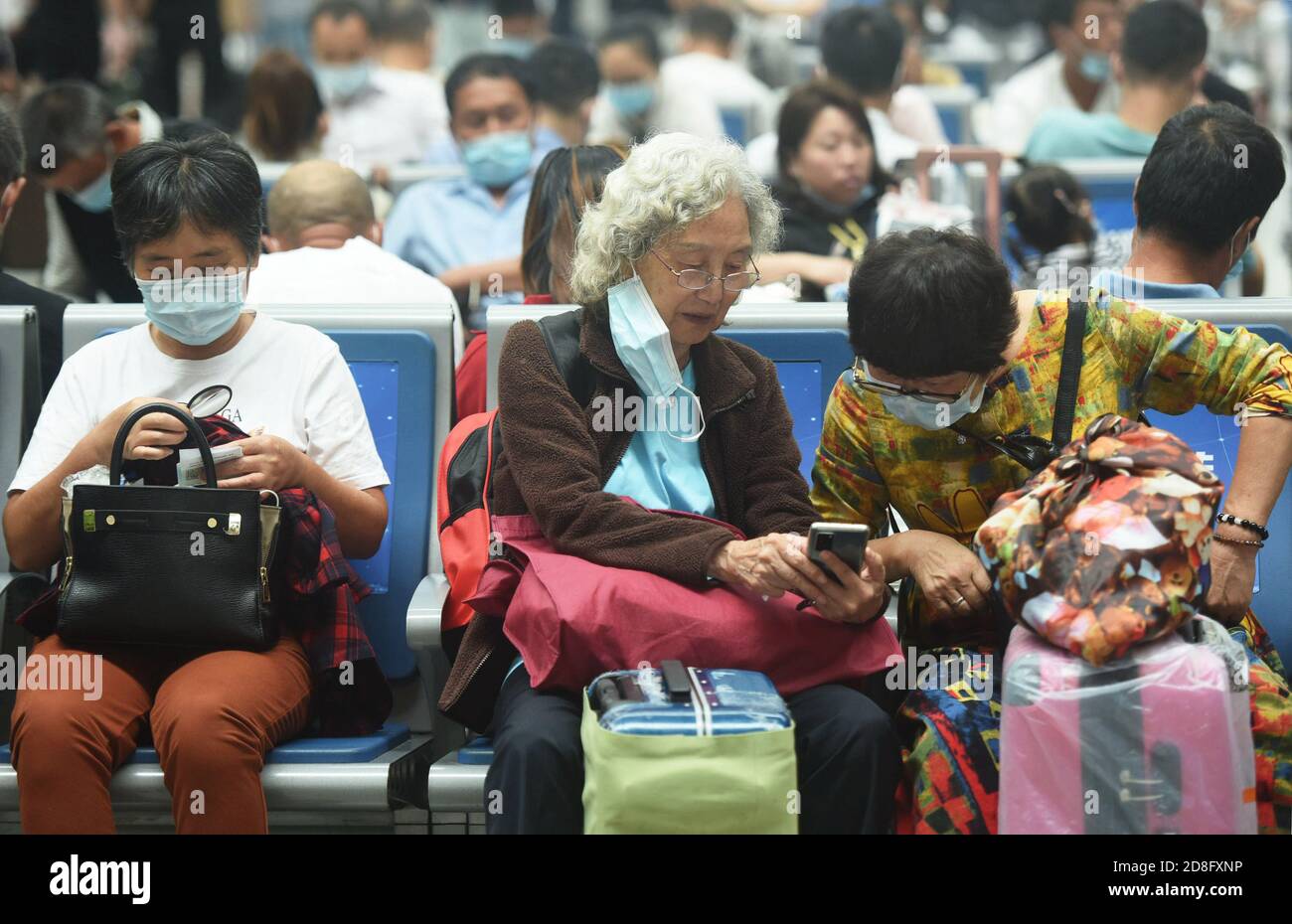People swarm into a train at East Hangzhou Station in Hangzhou city ...