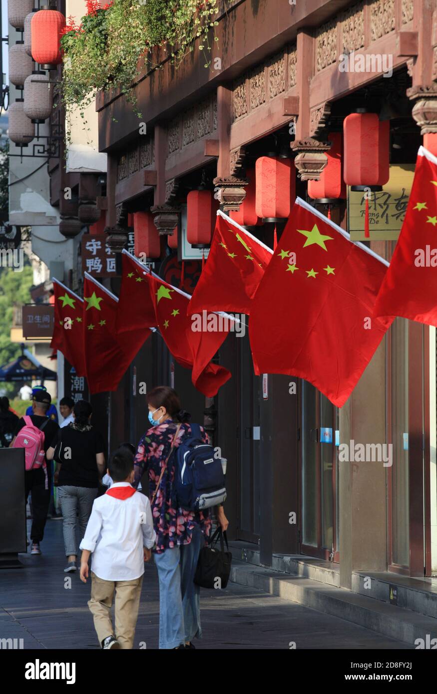A line of Chinese national flags fly on the street prior to the ...