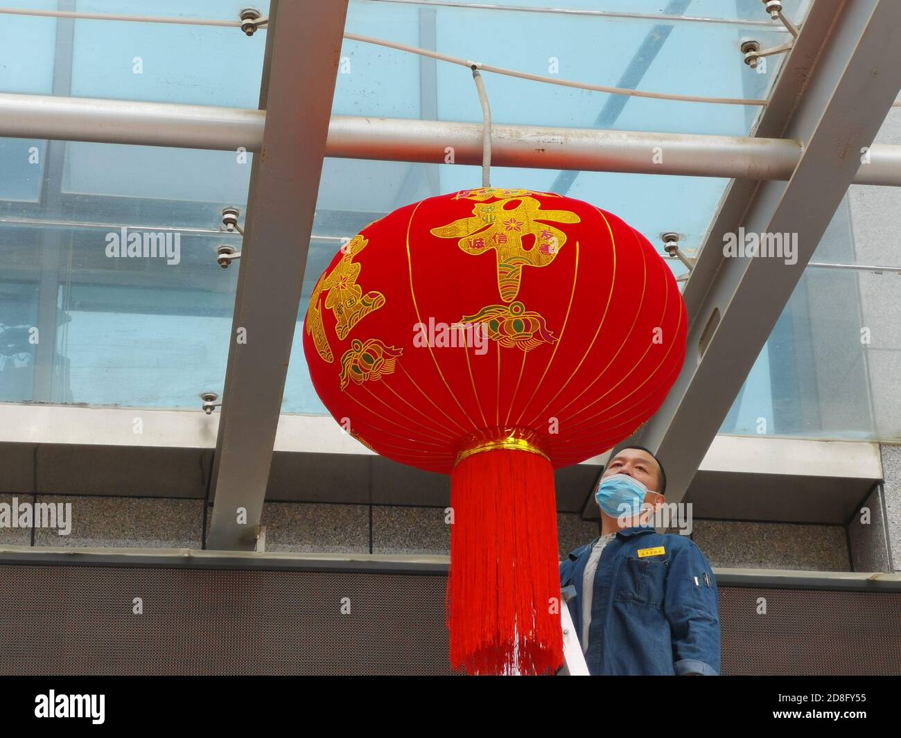 Red lanterns and national flags are seen flying along the Yihe street ...