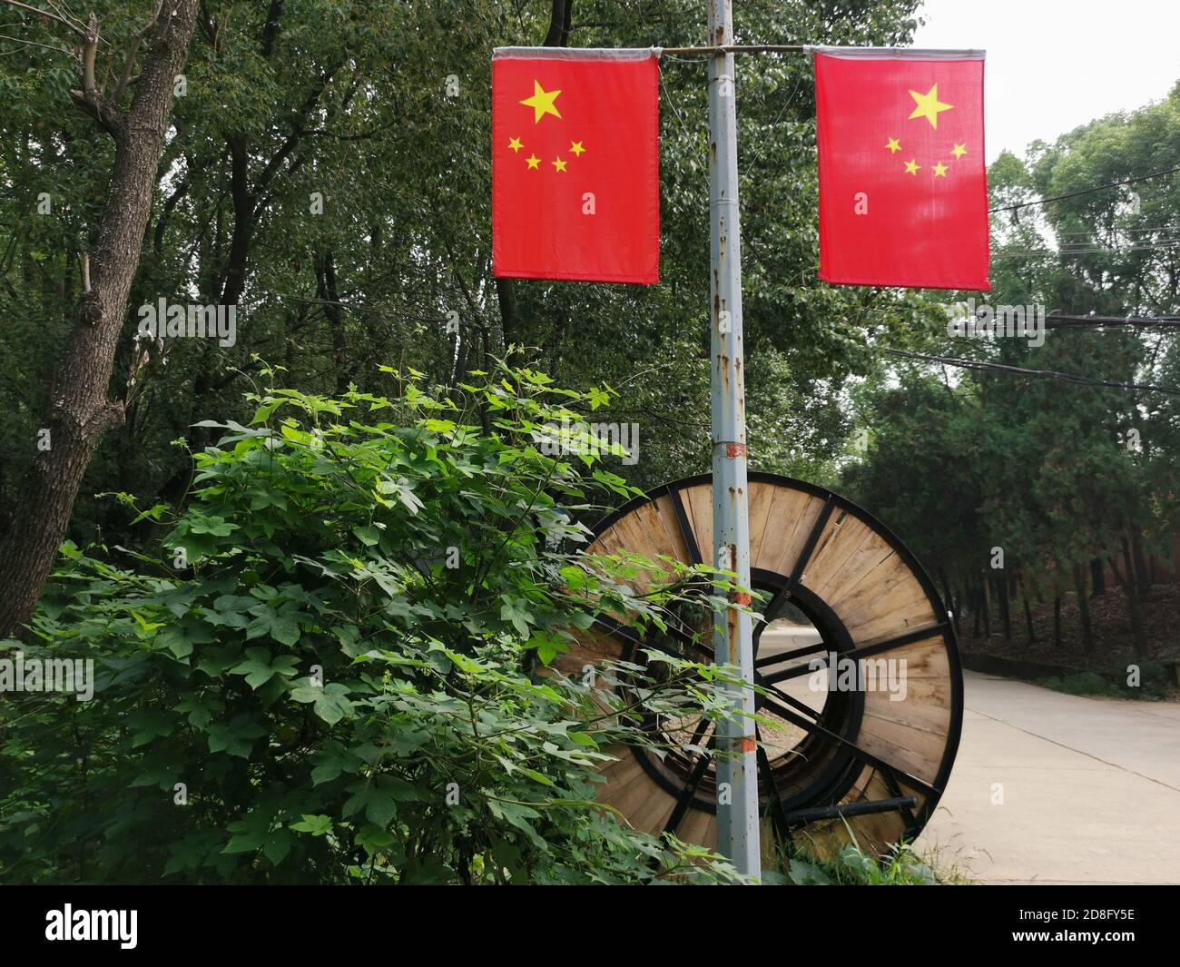 Red lanterns and national flags are seen flying along the Yihe street ...