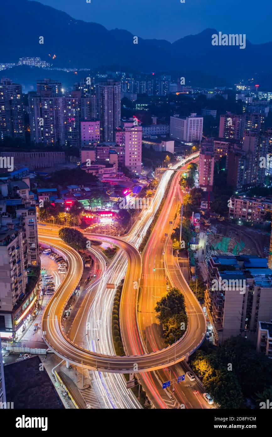 An aerial view of vehicles moving on a flyover which looks like an ...