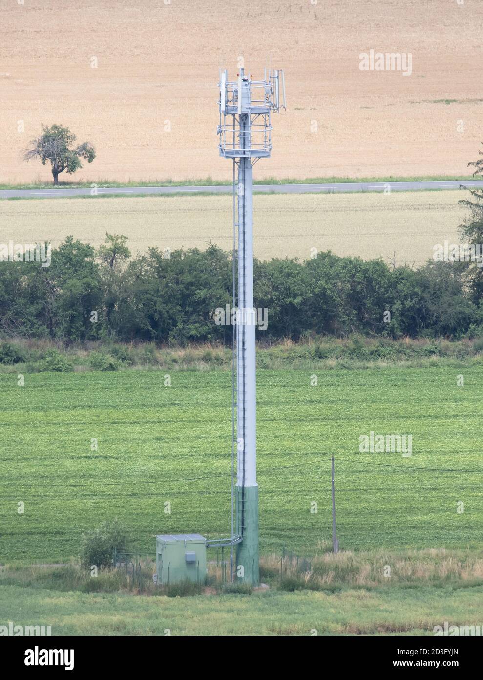 Cell phone tower in a green field Stock Photo - Alamy