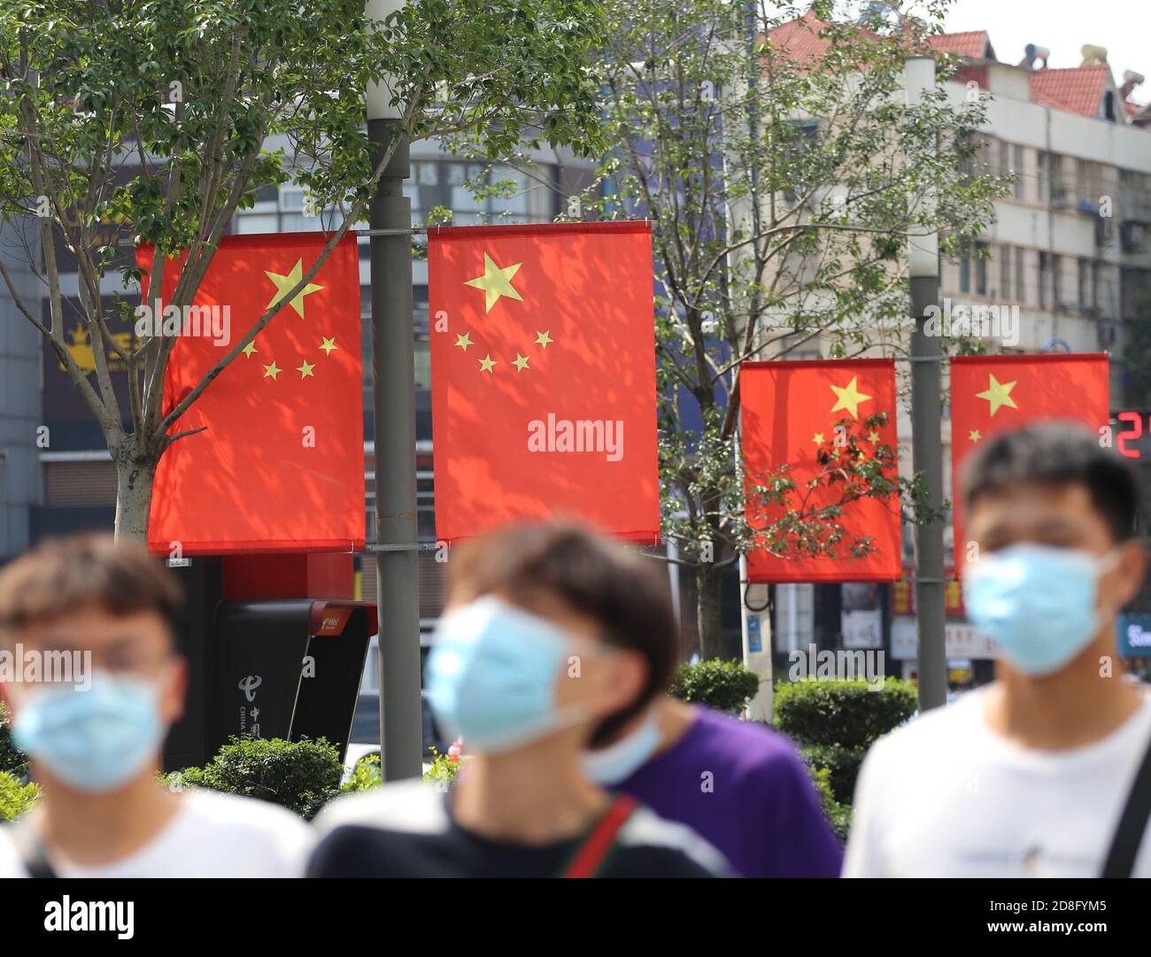 National flags of China are hung in the street light, welcoming the ...