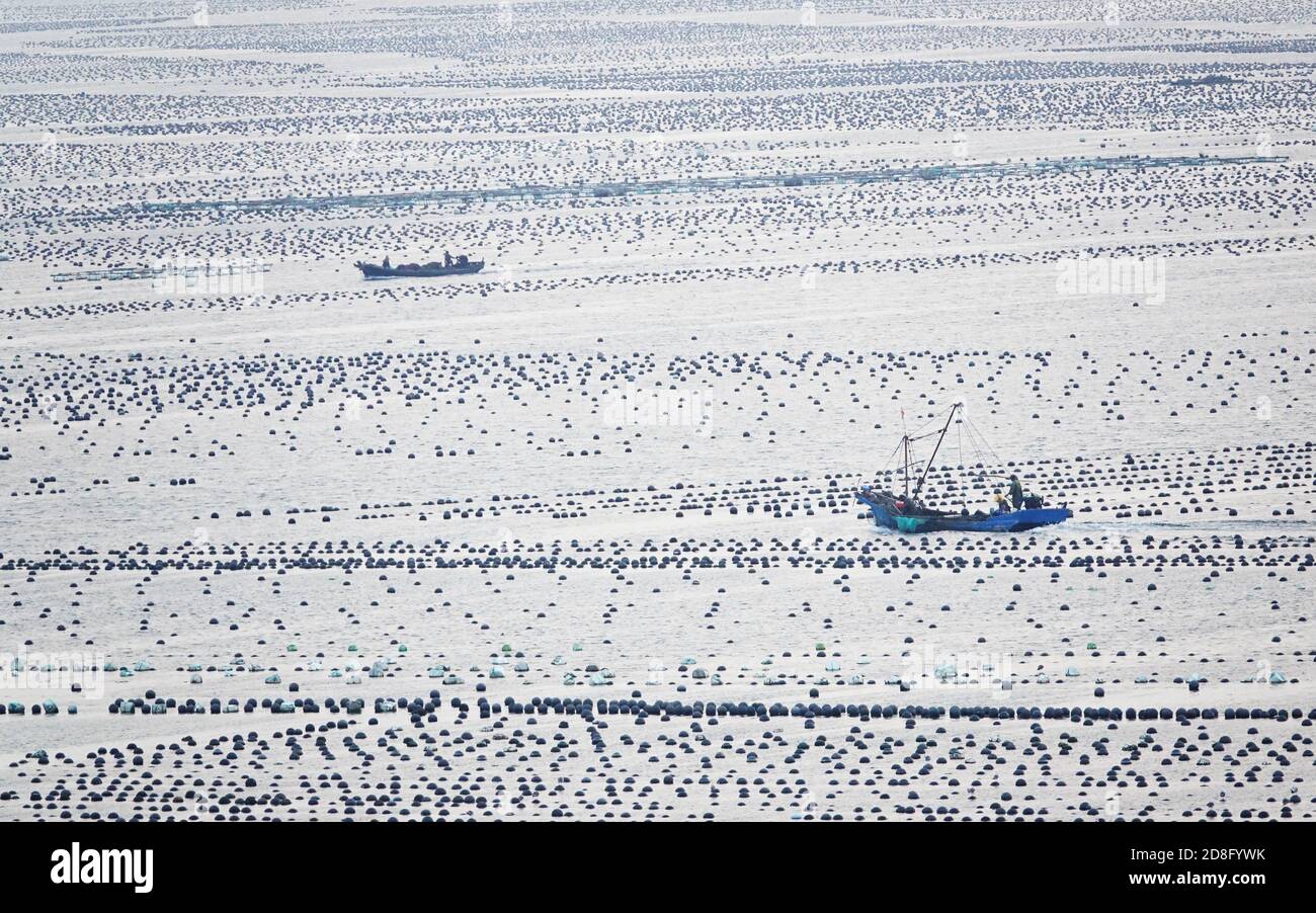 Aerial view of fishermen sailing a boat and fishing at the water aera ...