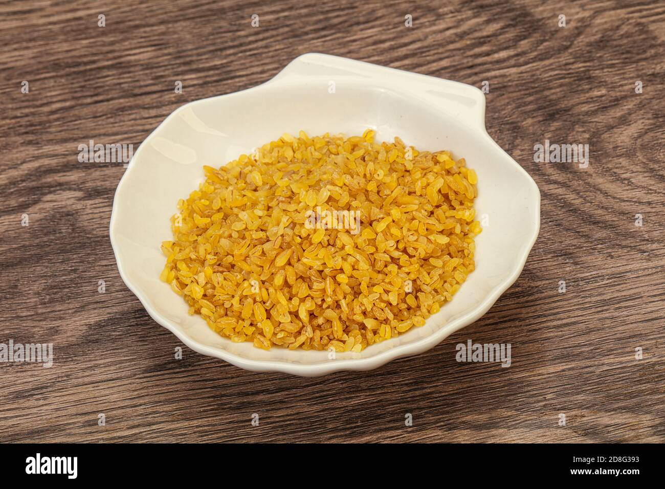Vegetarian cuisine - dry bulgur for cooking in the bowl Stock Photo - Alamy
