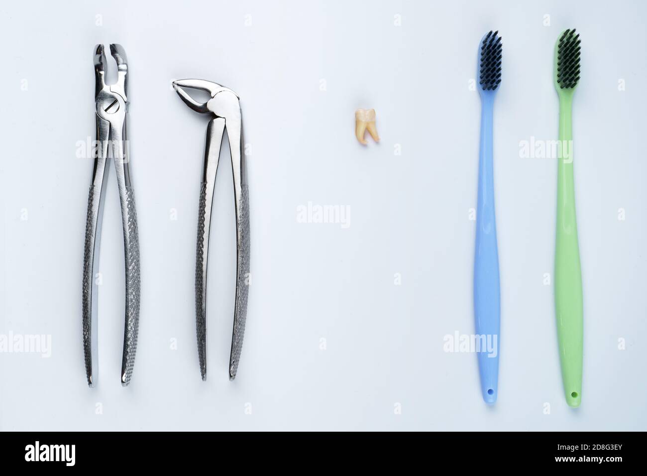 Shot of two dental tools with tooth on isolated white background Stock ...