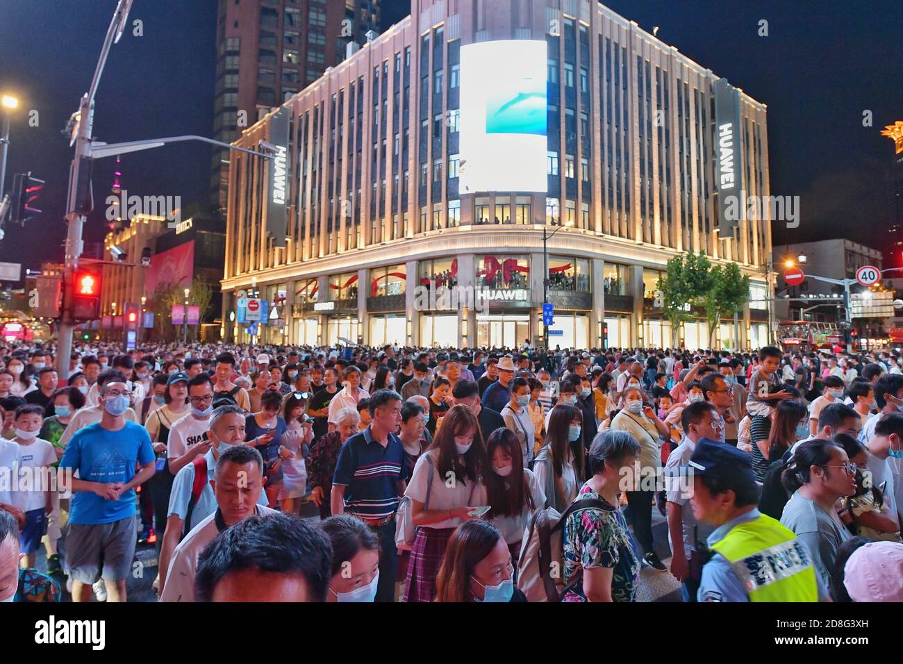 Tourists walk along the East Nanjing Road Pedestrian Street, dubbed ...