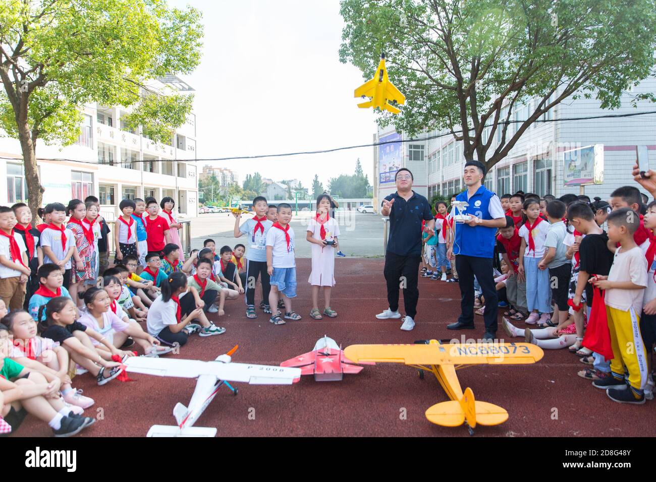 Guided by teachers, students who return to the campus as new semester ...