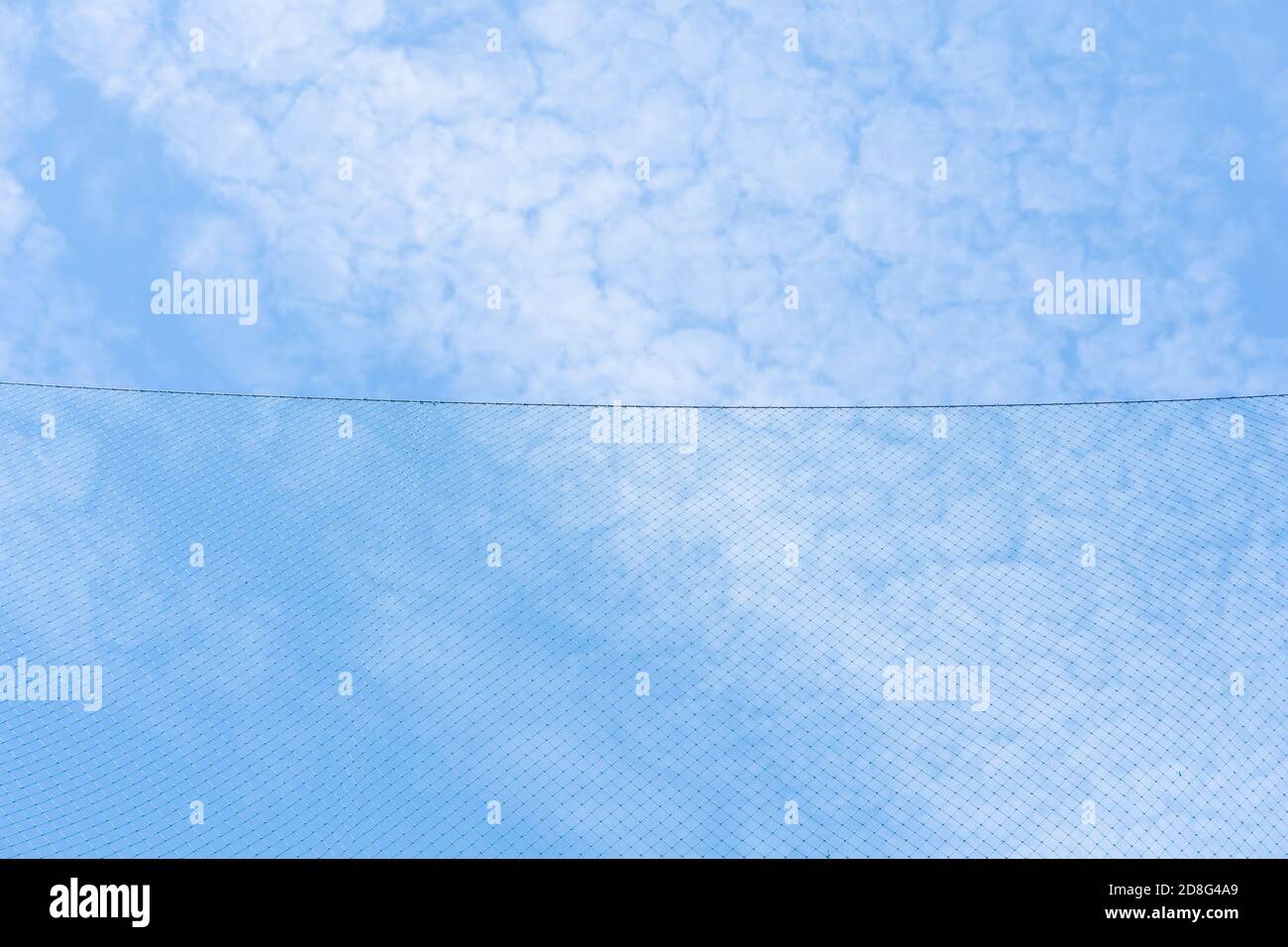 net mesh grid and blue sky background Stock Photo - Alamy