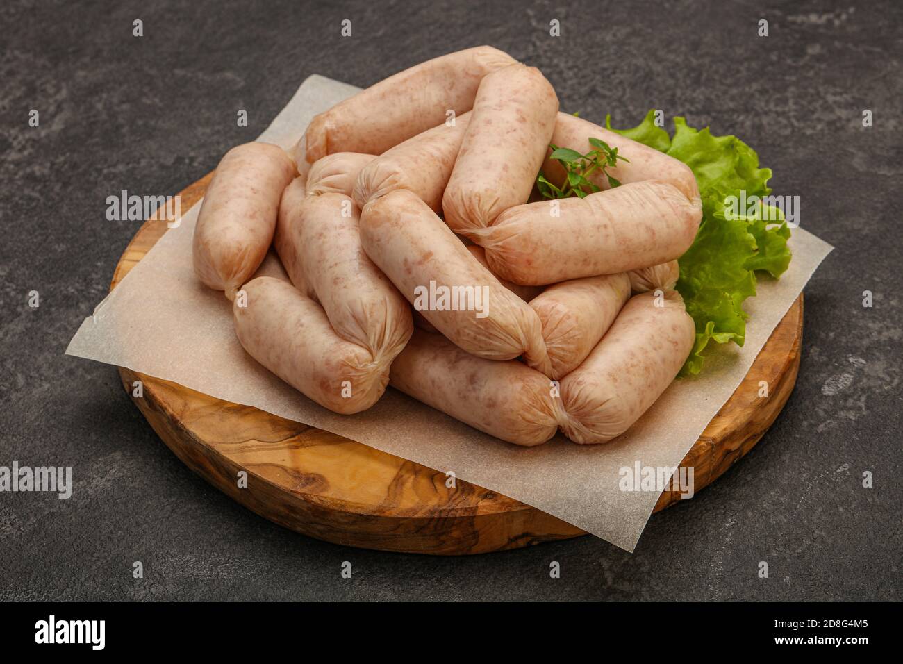 Raw natural chicken baby sausages for roast Stock Photo - Alamy