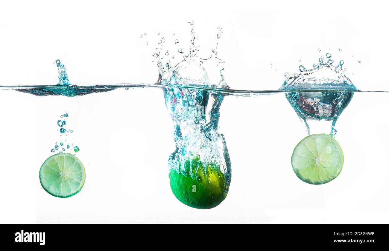 fresh lime splash in water on white background Stock Photo - Alamy