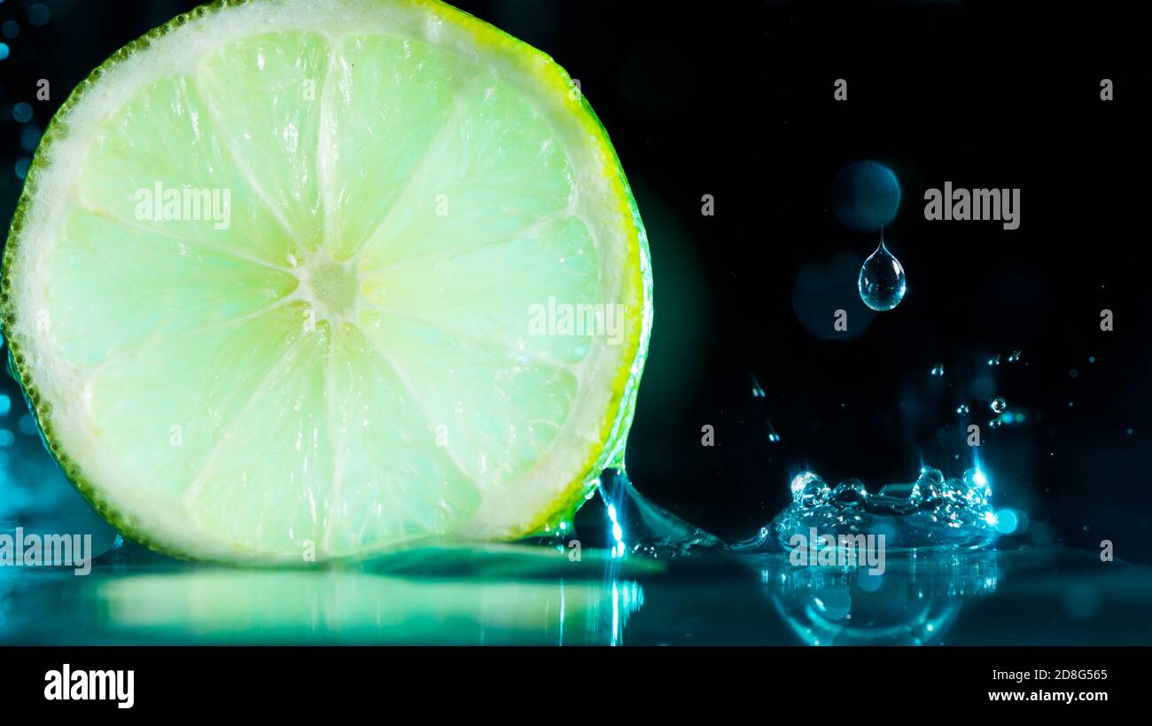 fresh lime splash in water on white background Stock Photo - Alamy
