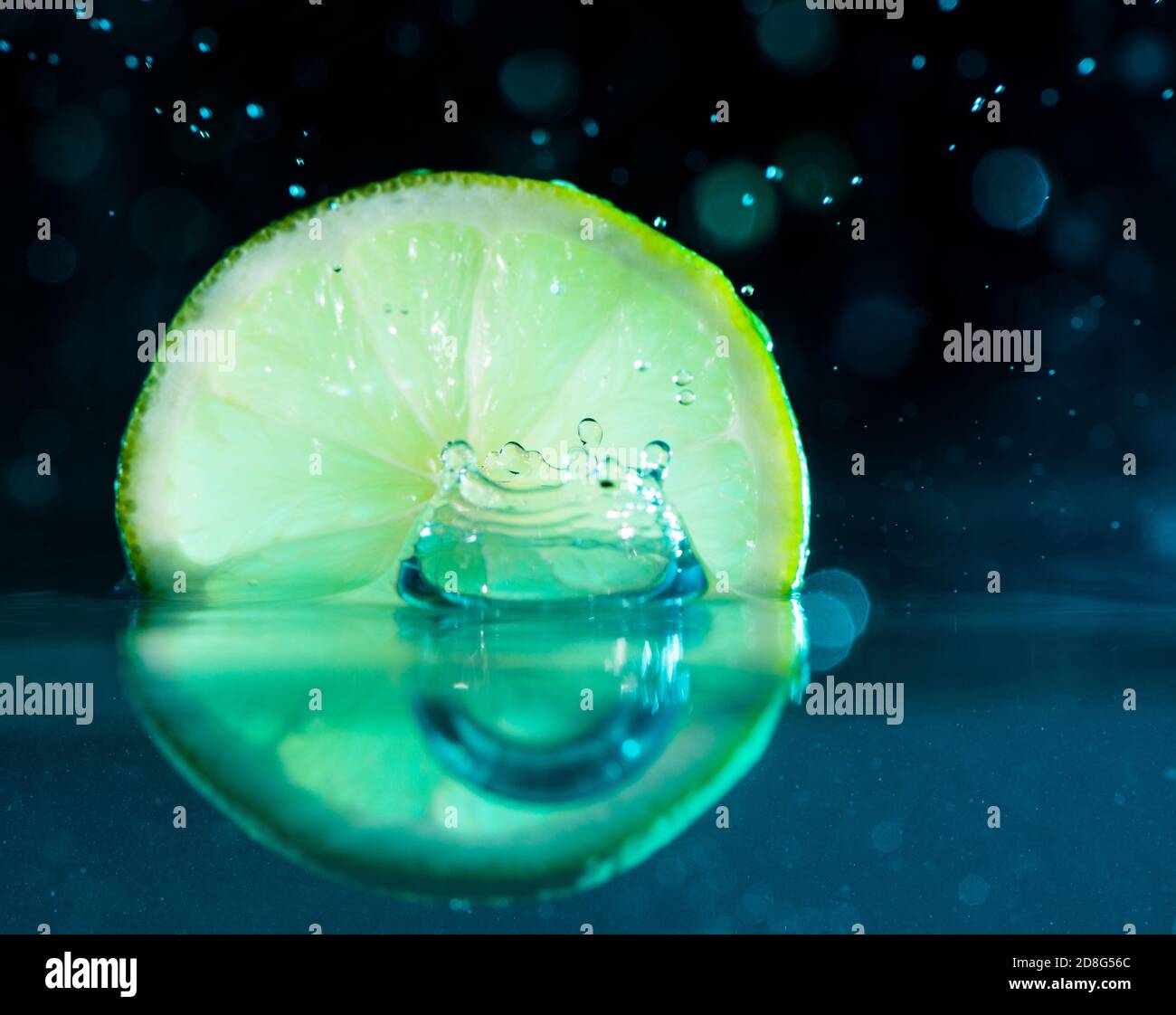 fresh lime splash in water on white background Stock Photo - Alamy