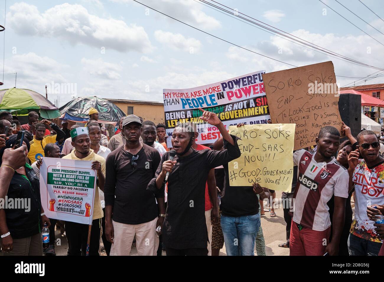 People raise fists and placards during protests against police ...