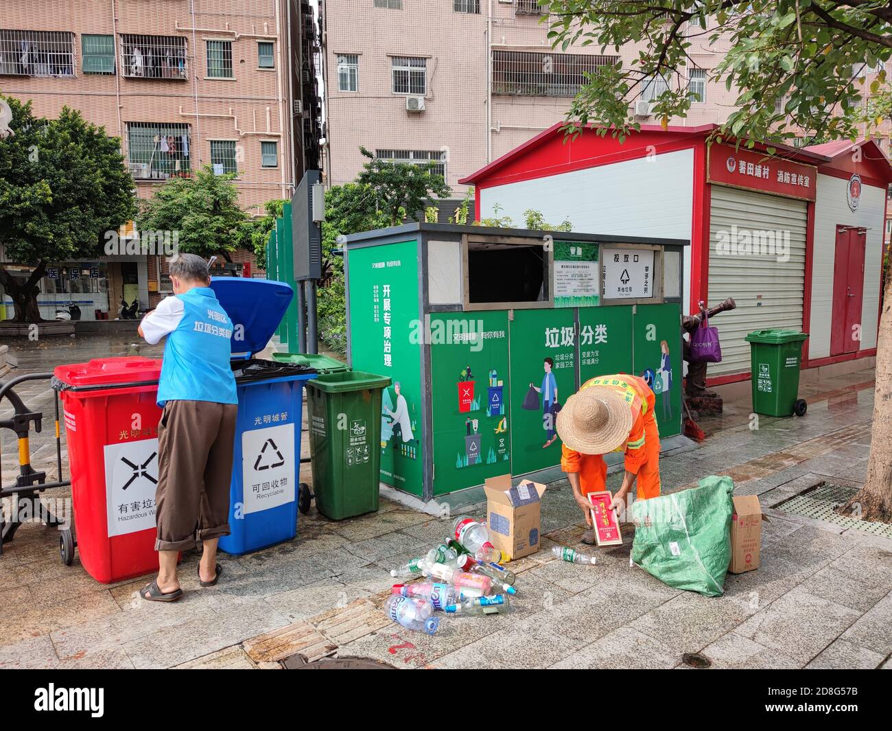 A worker cleans garbage at a garbage classification aera in a community ...