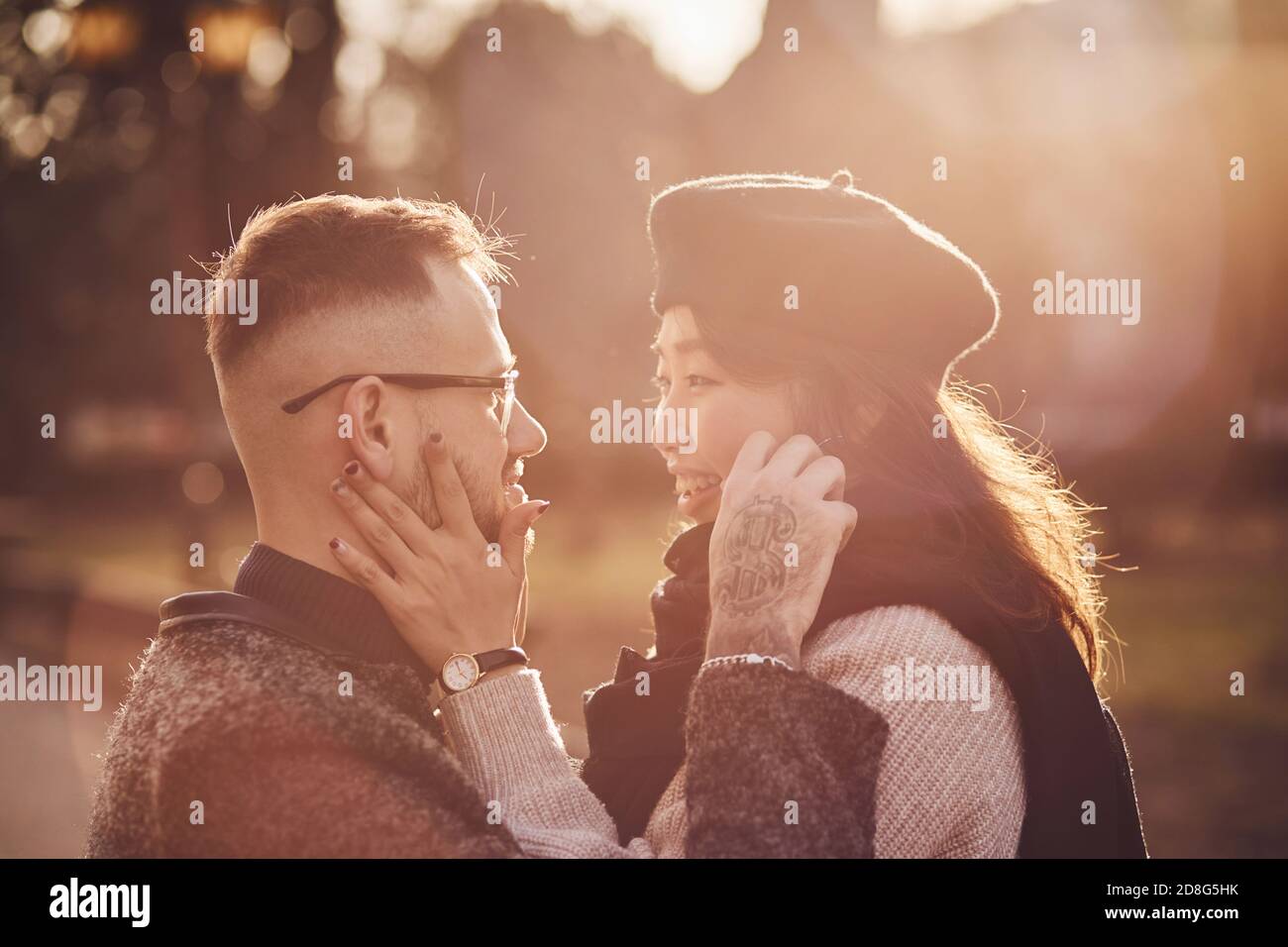 Beautiful sunlight. Happy multiracial couple together outdoors in the ...