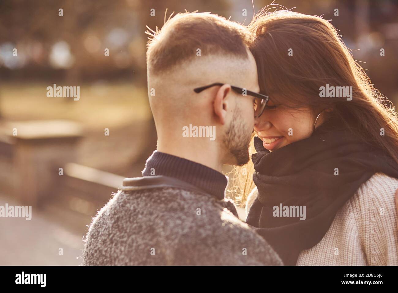 Beautiful sunlight. Happy multiracial couple together outdoors in the ...