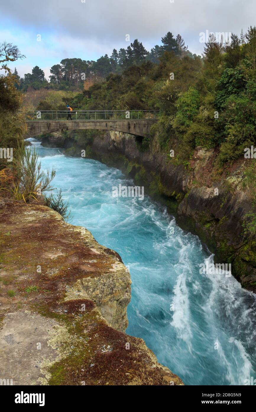 The mighty Waikato River rushing through a narrow gorge at Huka Falls ...