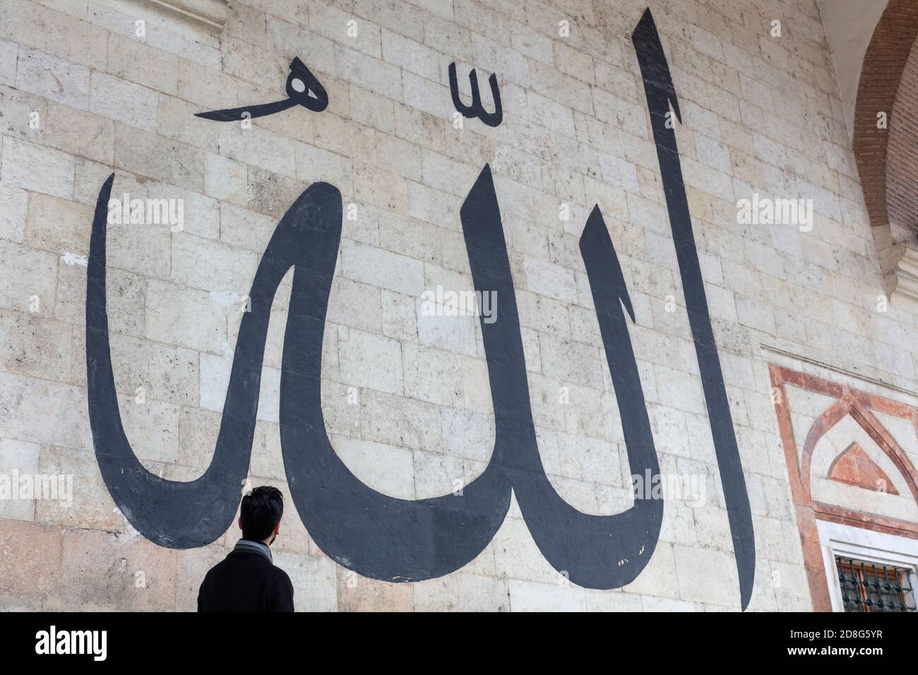 Young Man Staring at the Arabic Calligraphy meaning 'Allah-God in Islam ...