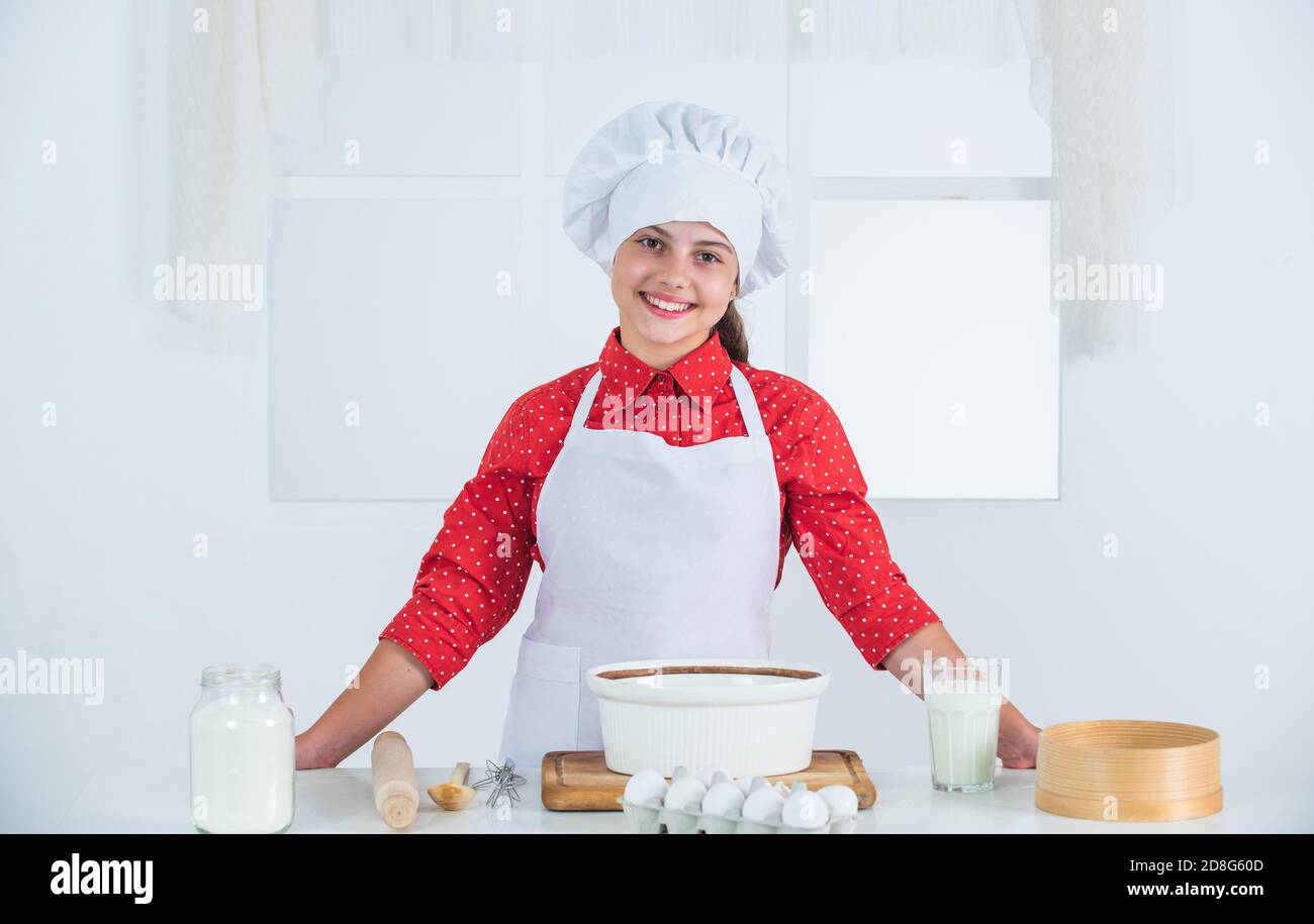 young baker girl in chef uniform, baking Stock Photo - Alamy