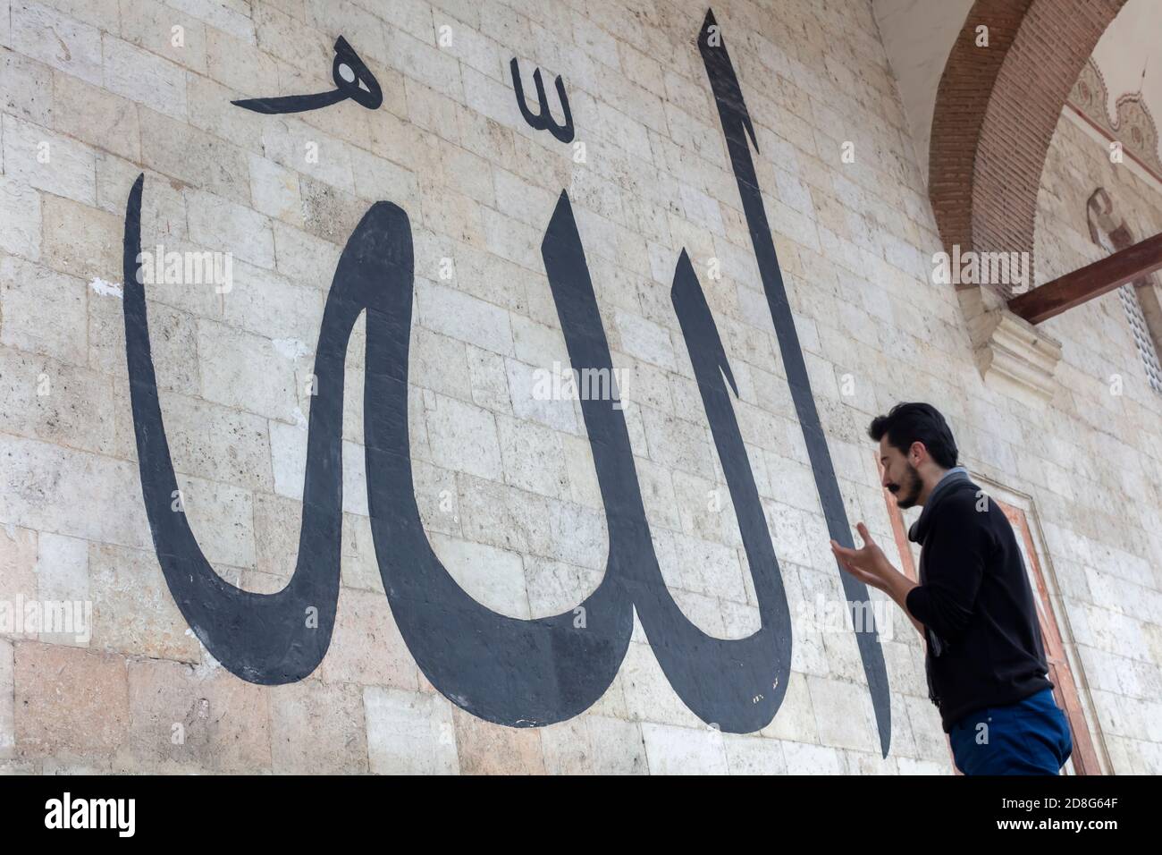 Young Man Staring at the Arabic Calligraphy meaning 'Allah-God in Islam ...