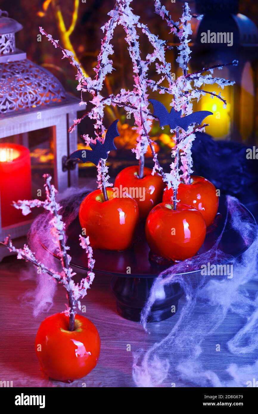 Halloween dessert. Poisoned blood caramelized glazed candy apple. Snow ...