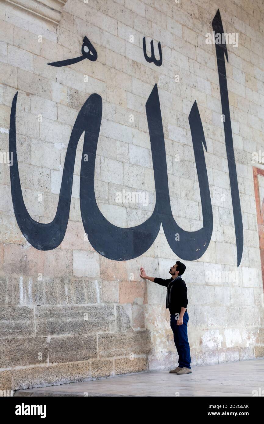 Young Man Staring at the Arabic Calligraphy meaning 'Allah-God in Islam ...