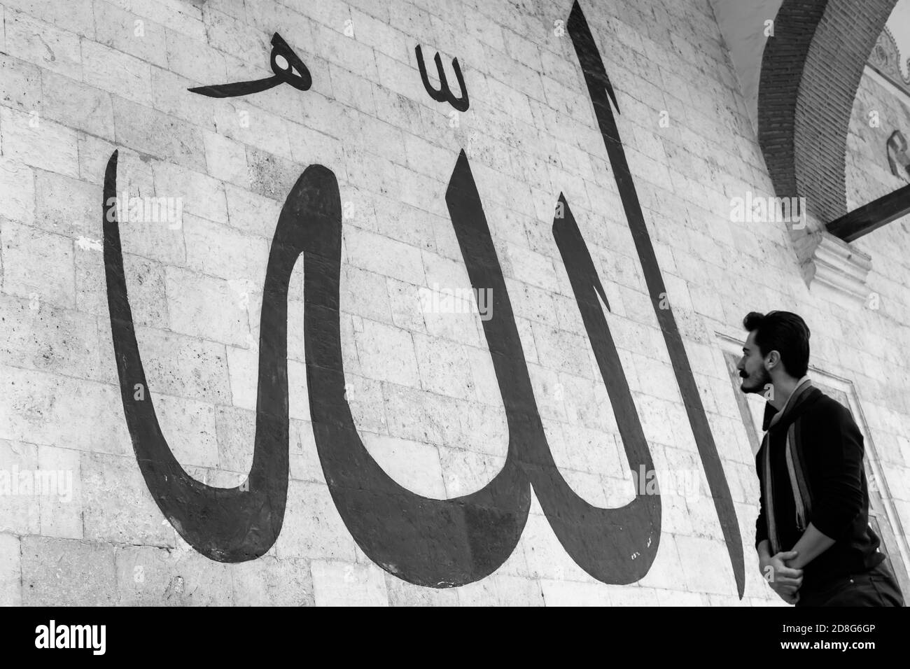 Young Man Staring at the Arabic Calligraphy meaning 'Allah-God in Islam ...