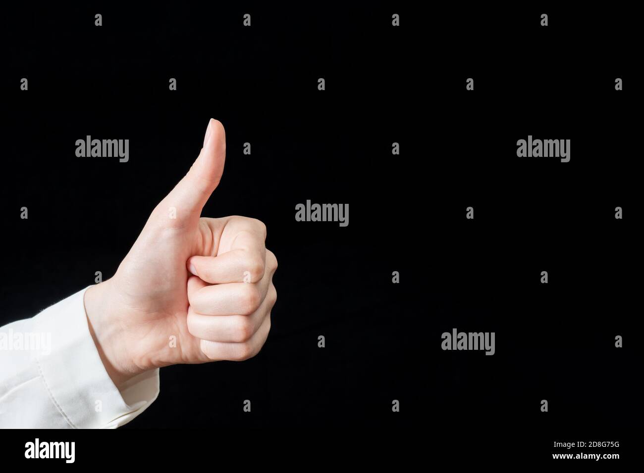 Close-up of hand finger up isolated on black background. A female hand ...