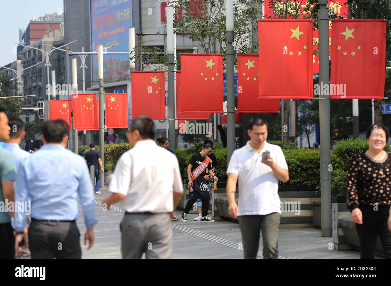 National flags of China are hung in the street light, welcoming the ...