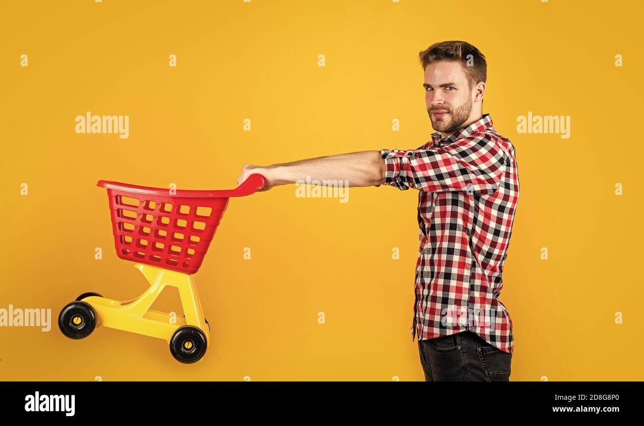 customer pushing cart. buyer in supermarket. empty toy trolley. man go ...