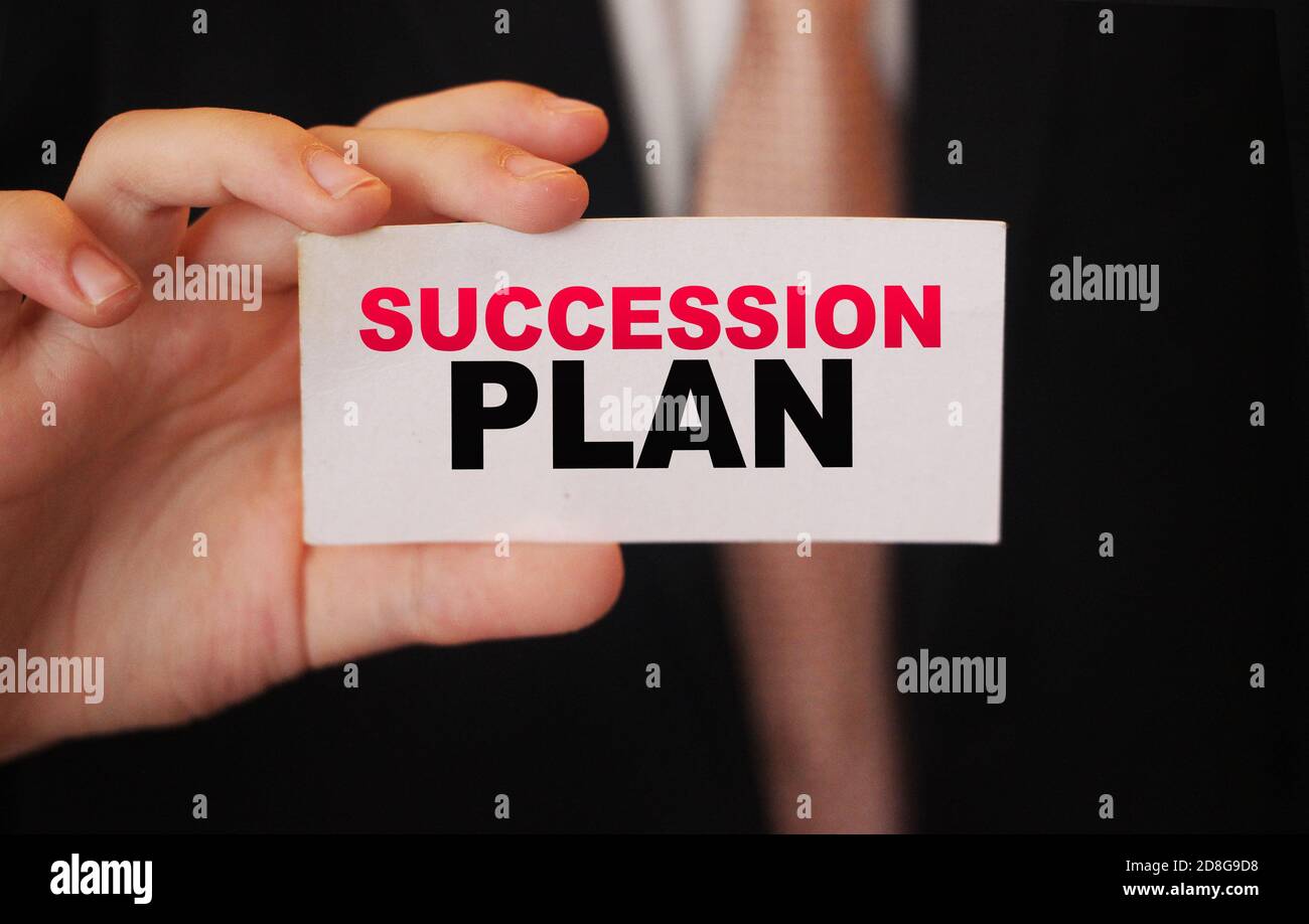 Succession Plan words on a card in hand of businessman. Business profit ...