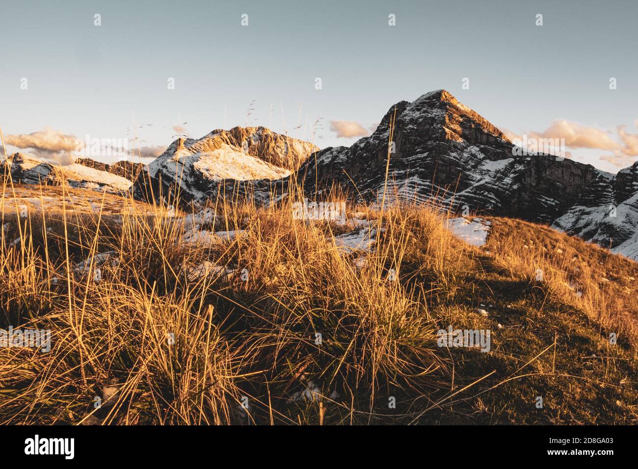 Dry sunlit landscape with rugged immense rock formations covered with ...